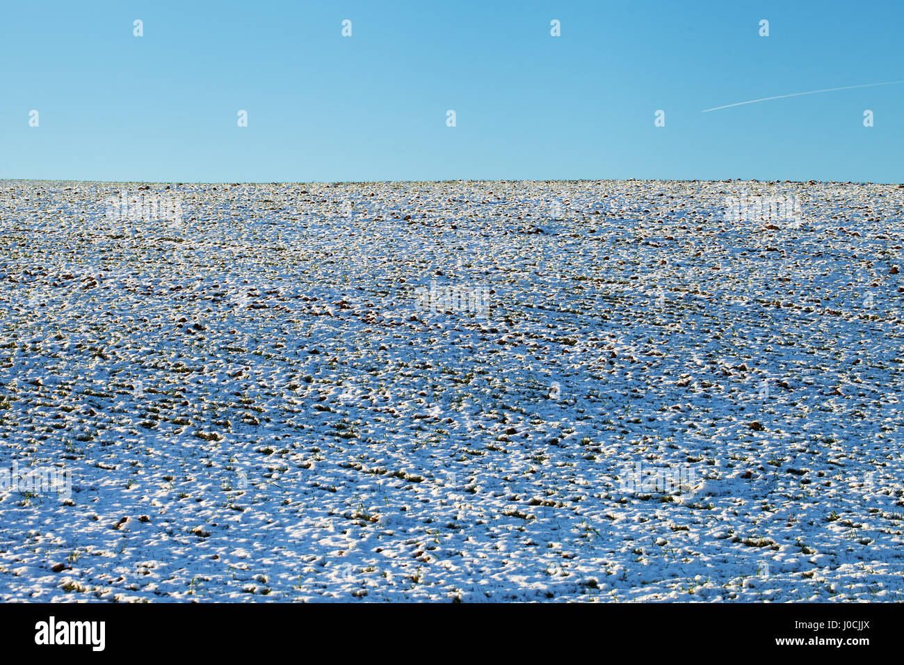 Snow, land and blue sky Stock Photo - Alamy