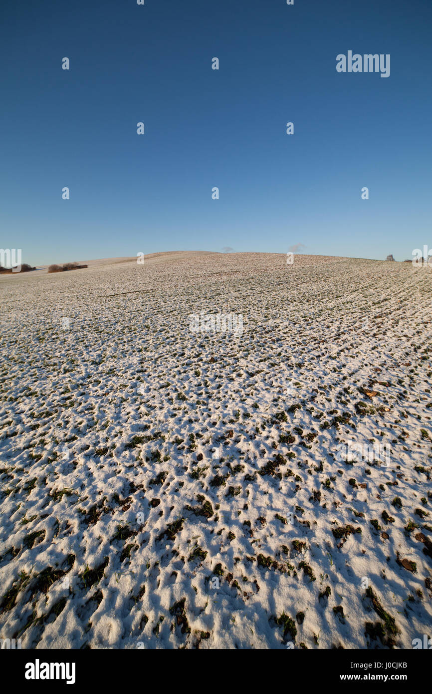 Snow, land and blue sky Stock Photo - Alamy