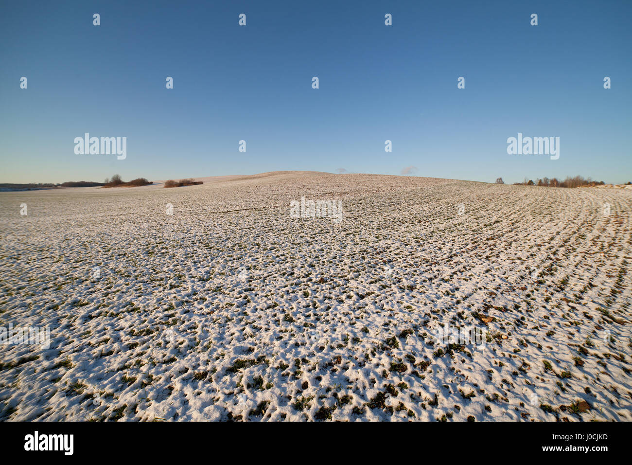 Snow, land and blue sky Stock Photo - Alamy