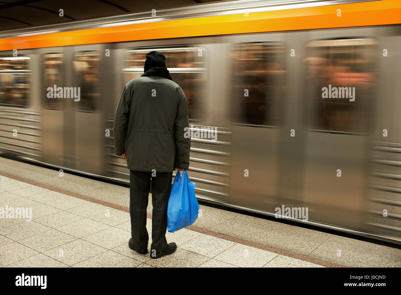 Man waiting for the train in a metro station Stock Photo - Alamy