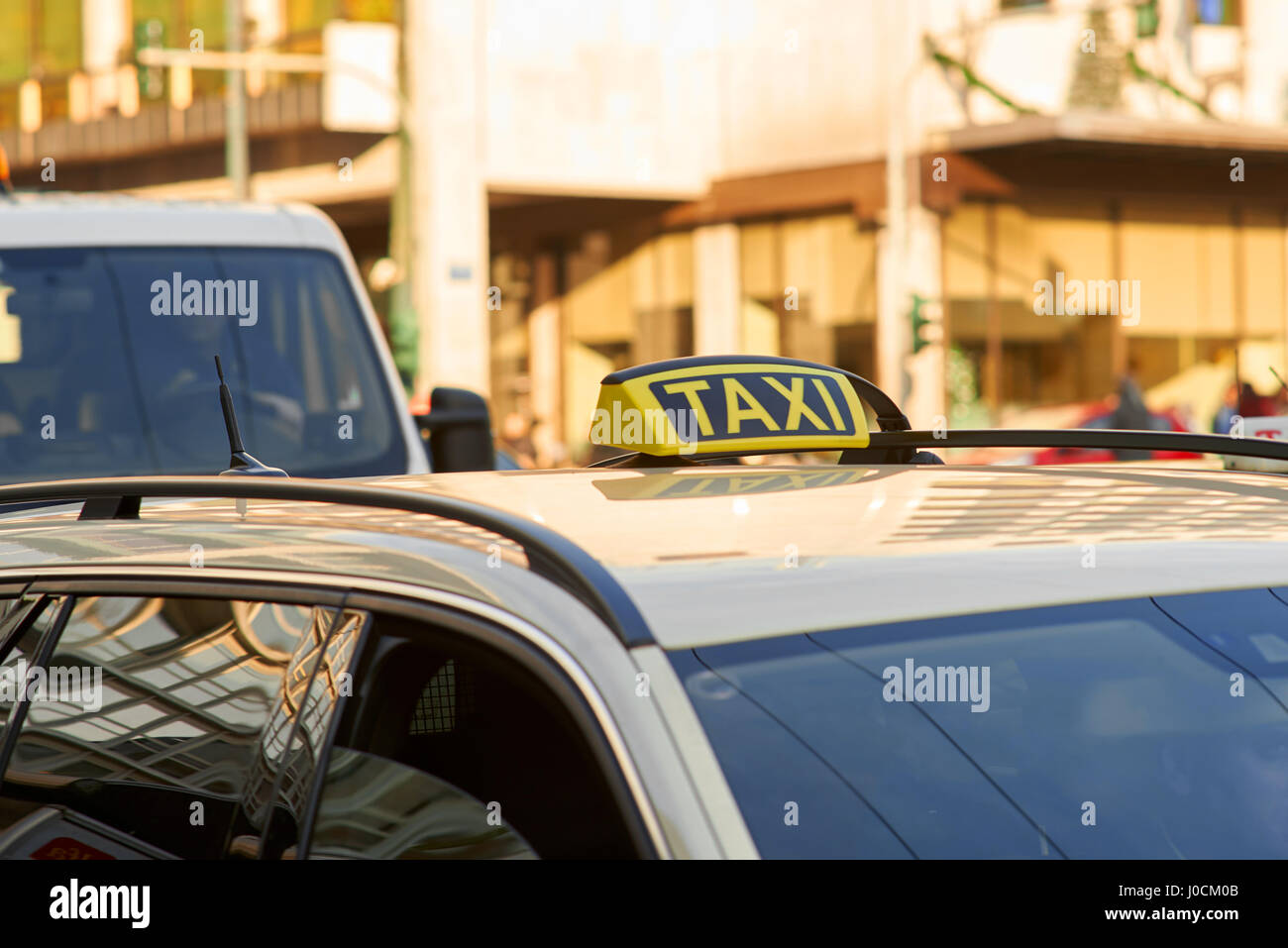 Yellow cab with taxi sign on roof waiting for passengers to pick up ...