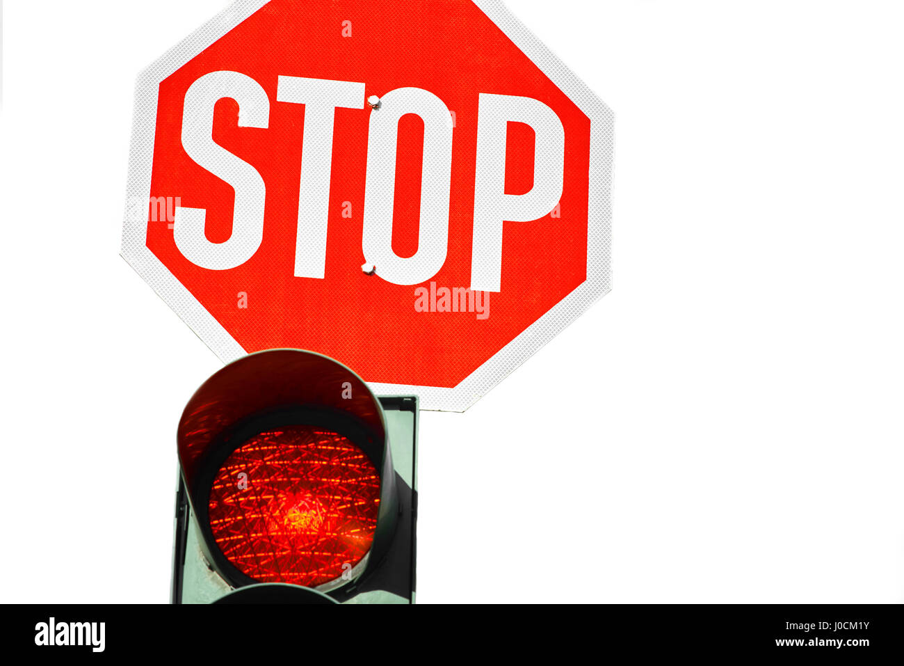 Red traffic light and a stop sign Stock Photo - Alamy