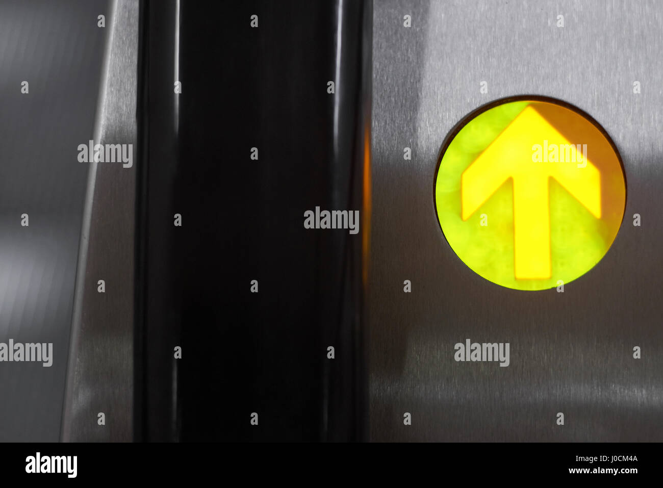 Yellow arrow symbol on escalator stairs Stock Photo - Alamy