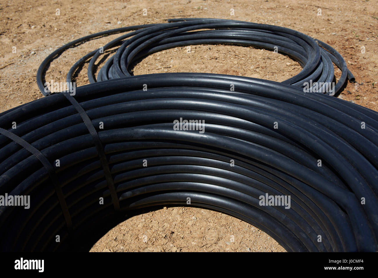 Stacks of black pvc plastic pipe for watering network to gardens Stock ...