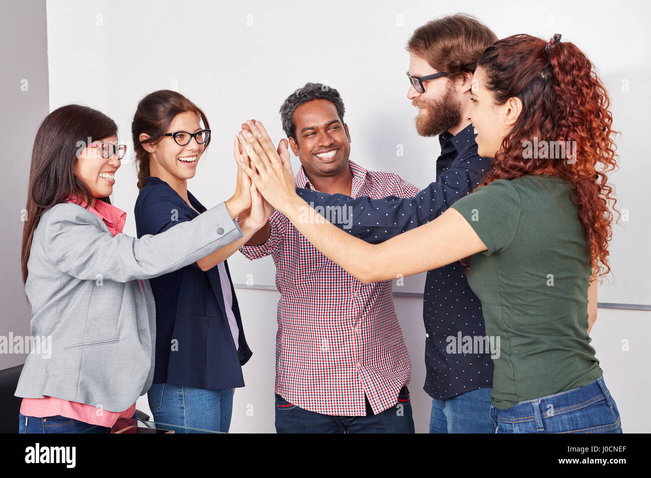 Team High Five in startup with successful creative business team Stock ...