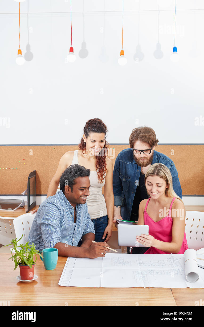 Young startup team meeting with tablet computer planning Stock Photo ...