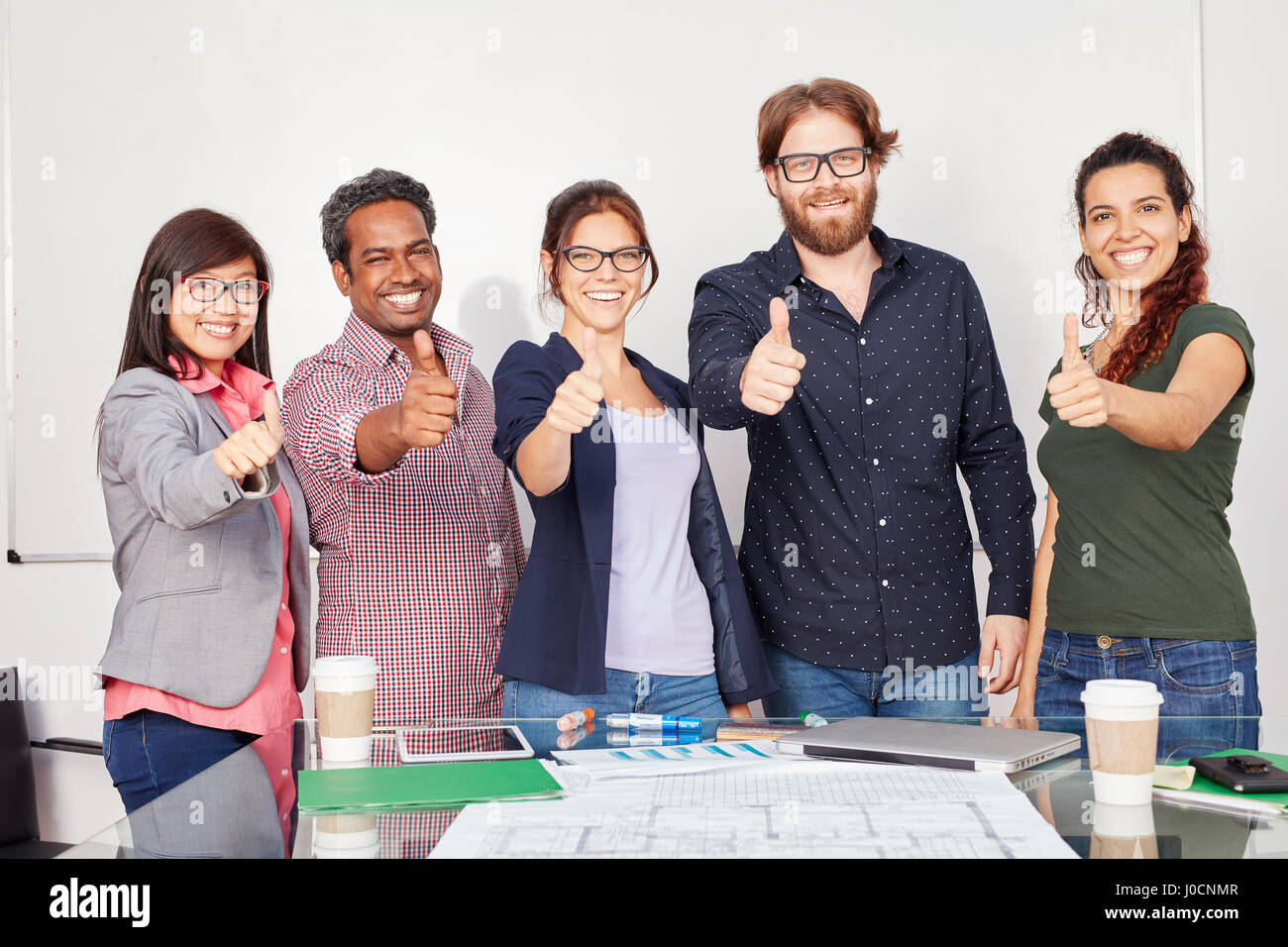 Successful start up team with thumbs up as congratulations Stock Photo ...