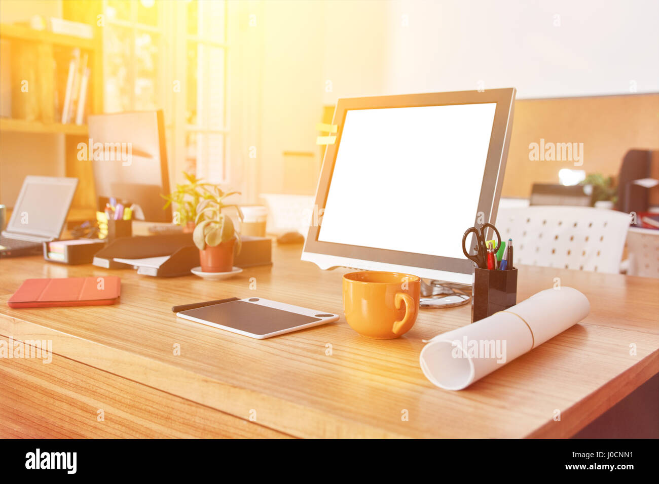Computer monitor on desk in coworking office Stock Photo - Alamy