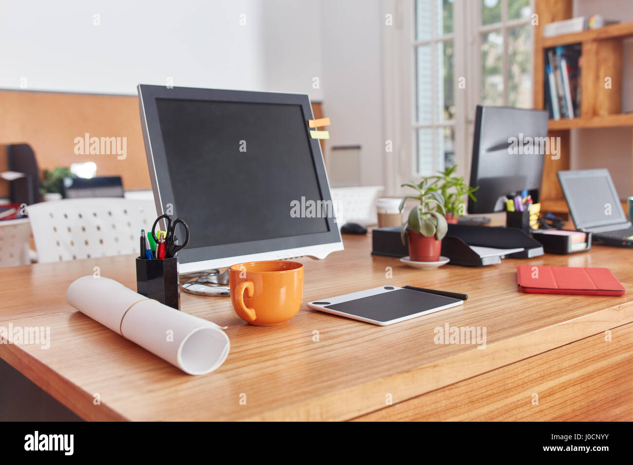 Place of work with desk and computer in coworking office sharing ...