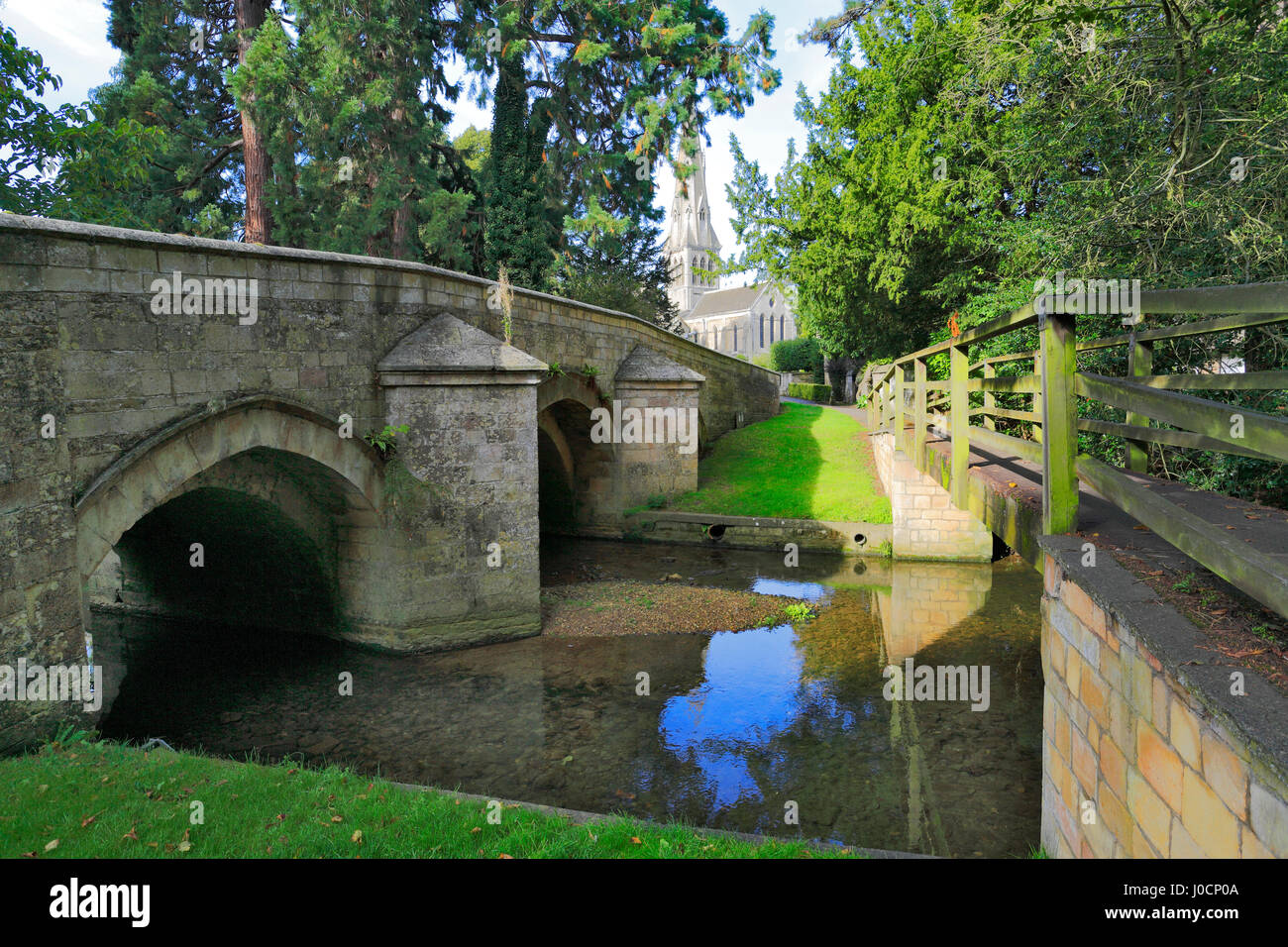 River Chater stone bridge, St Marys church, Ketton village Rutland ...