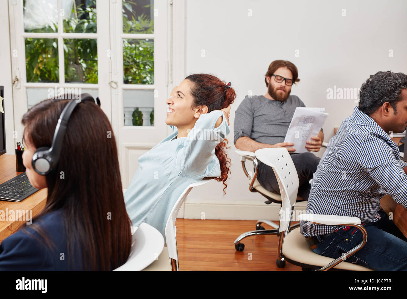 Call center team servicing as consultant operators Stock Photo - Alamy