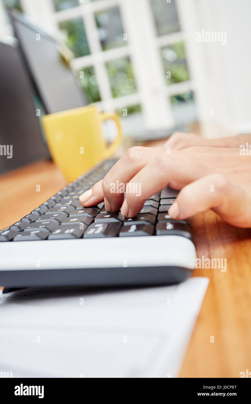 Man typing on computer keyboard on office desk Stock Photo - Alamy
