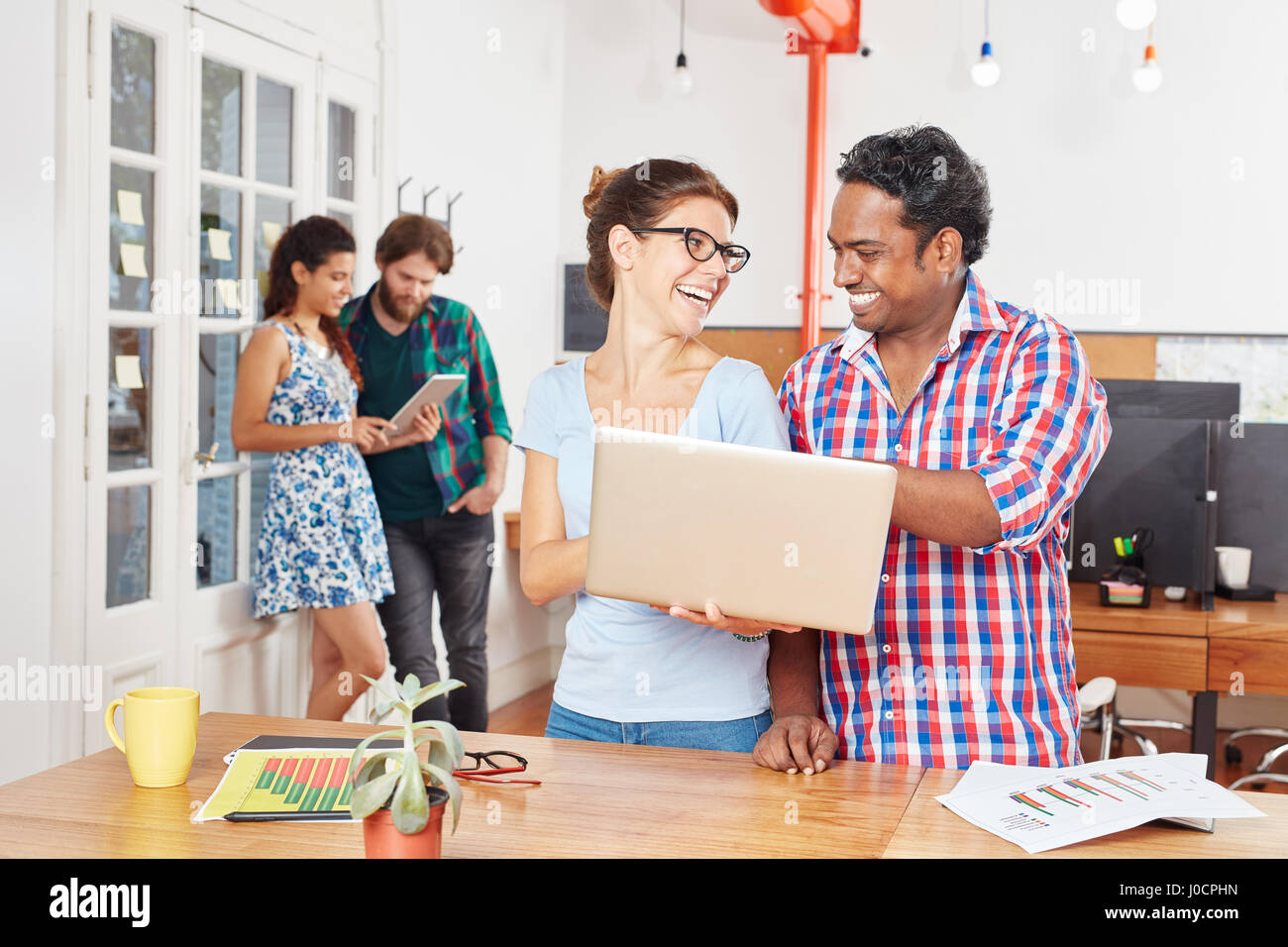Startup colleagues fun teamwork in coworking office Stock Photo - Alamy