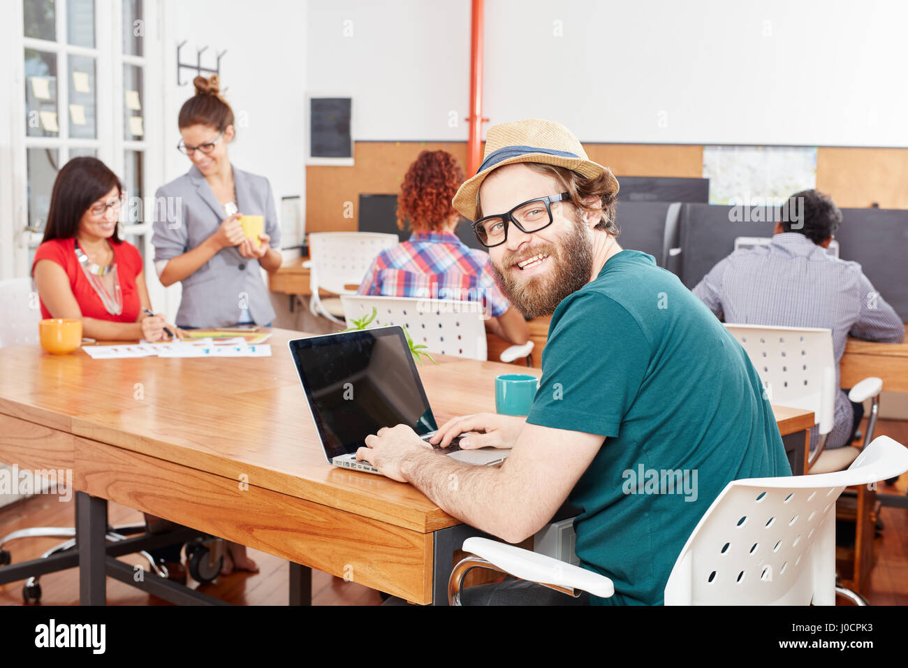 Nerd programmer with laptop in IT startup Stock Photo - Alamy