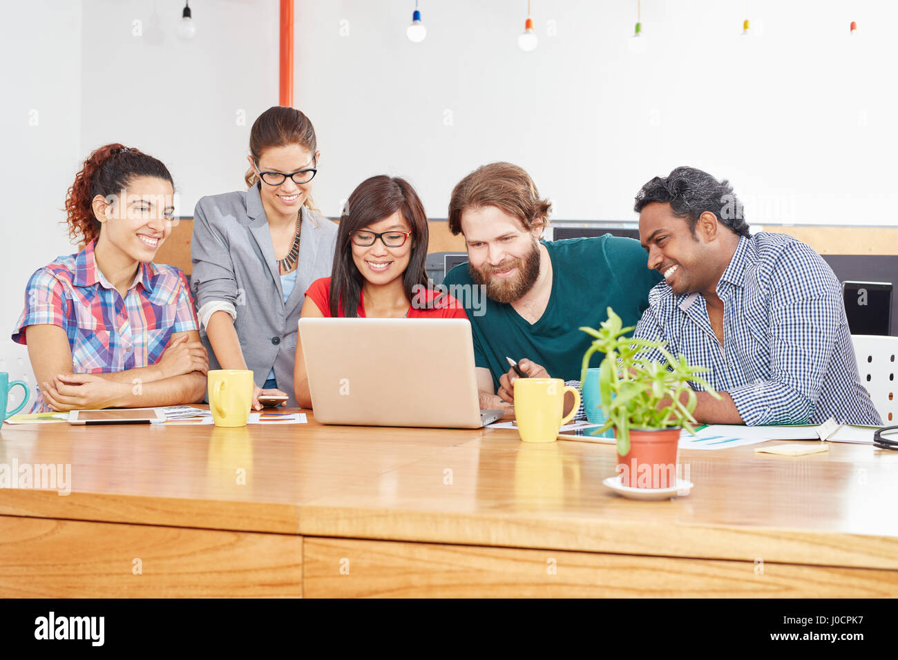Startup meeting with computer using internet for social media Stock ...