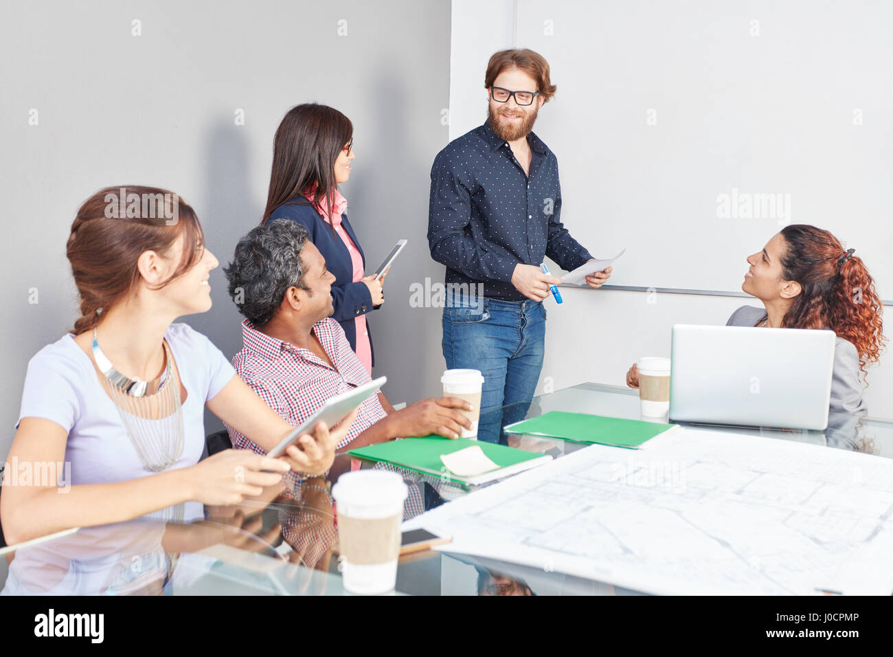 Team in business meeting presentation with whiteboard Stock Photo - Alamy