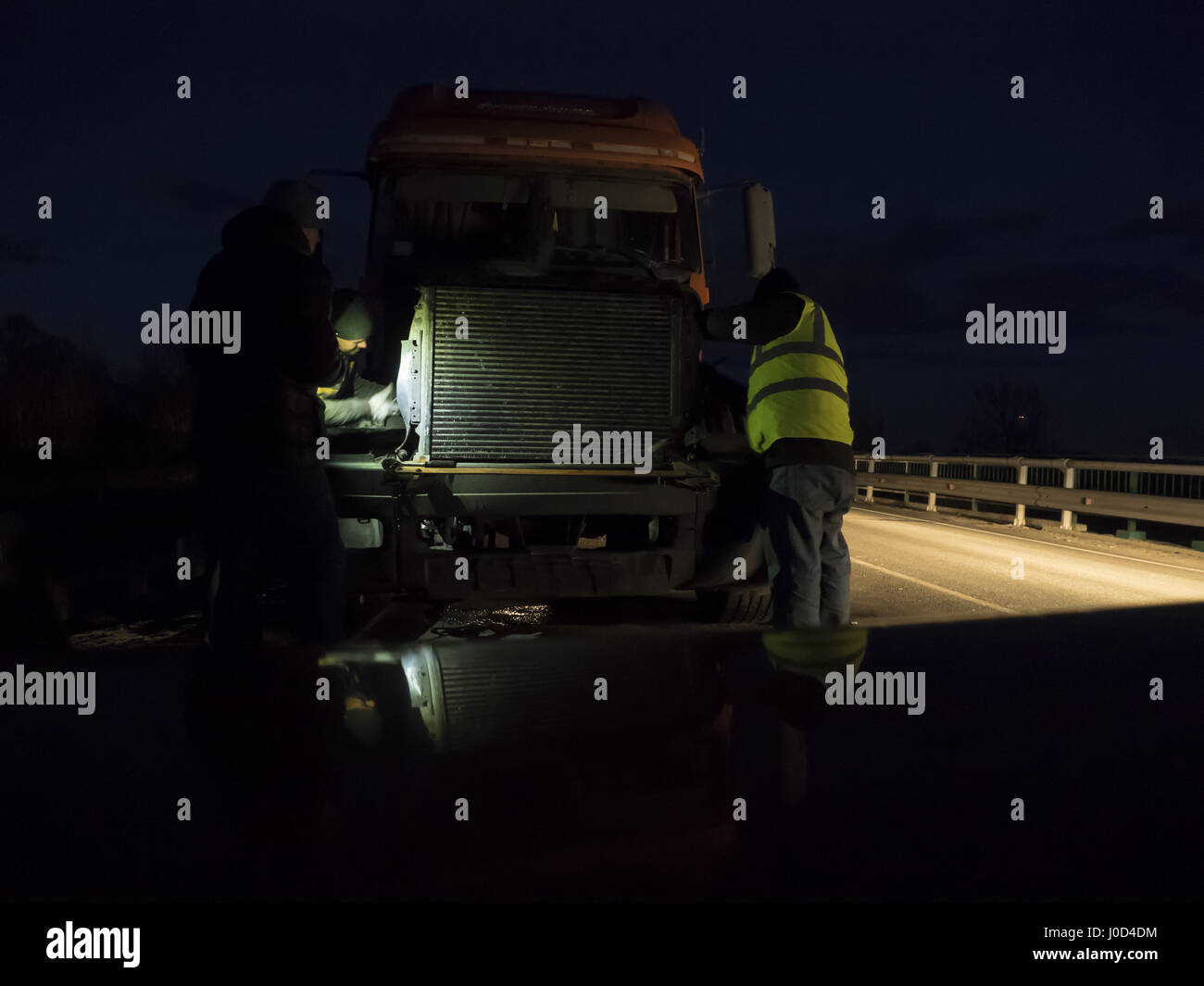 Mechanics repair in the field at the night the truck damaged during the ...