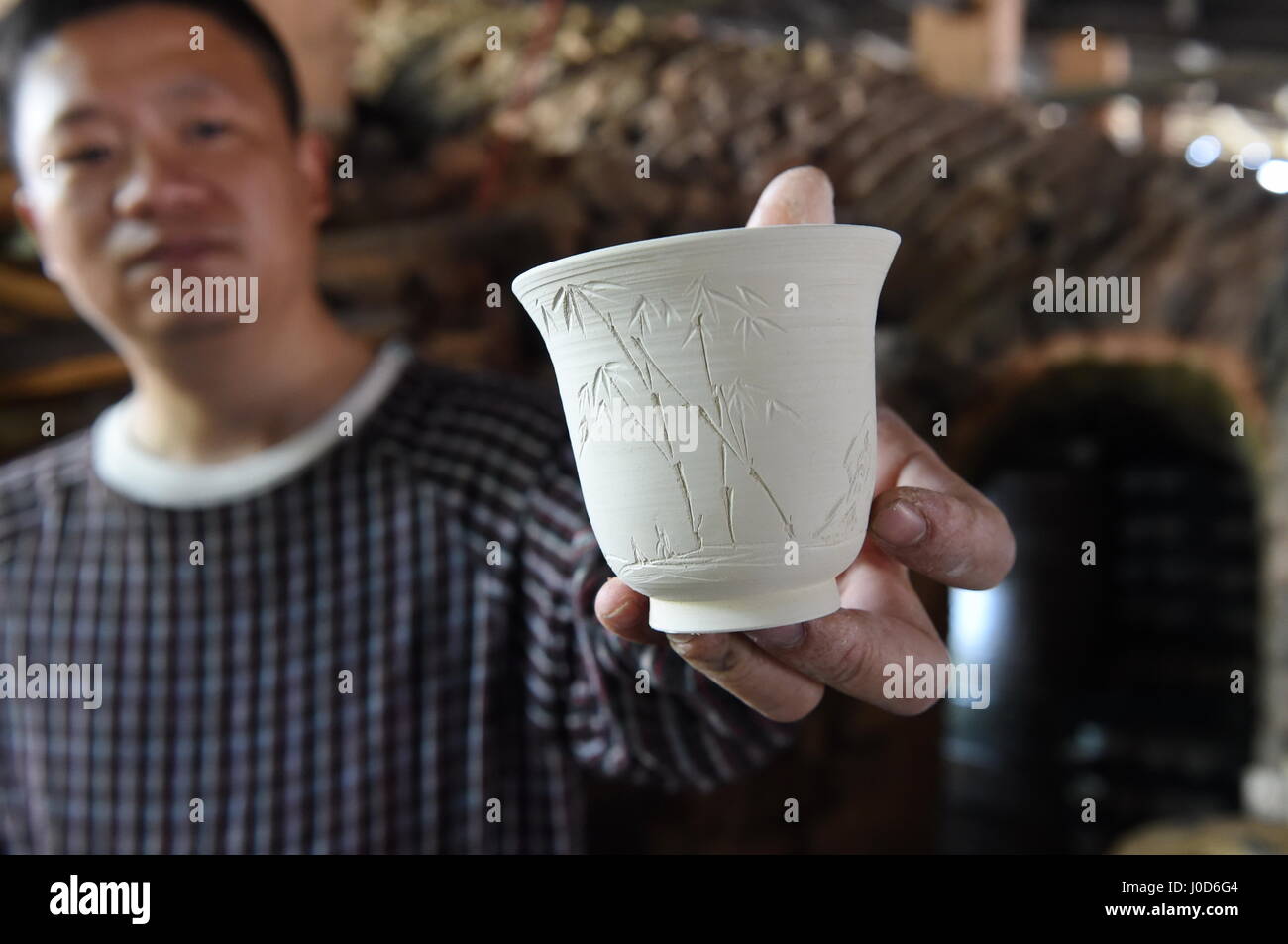 Dehua. 11th Apr, 2017. Ceramic artist Huang Guanghua shows an ...