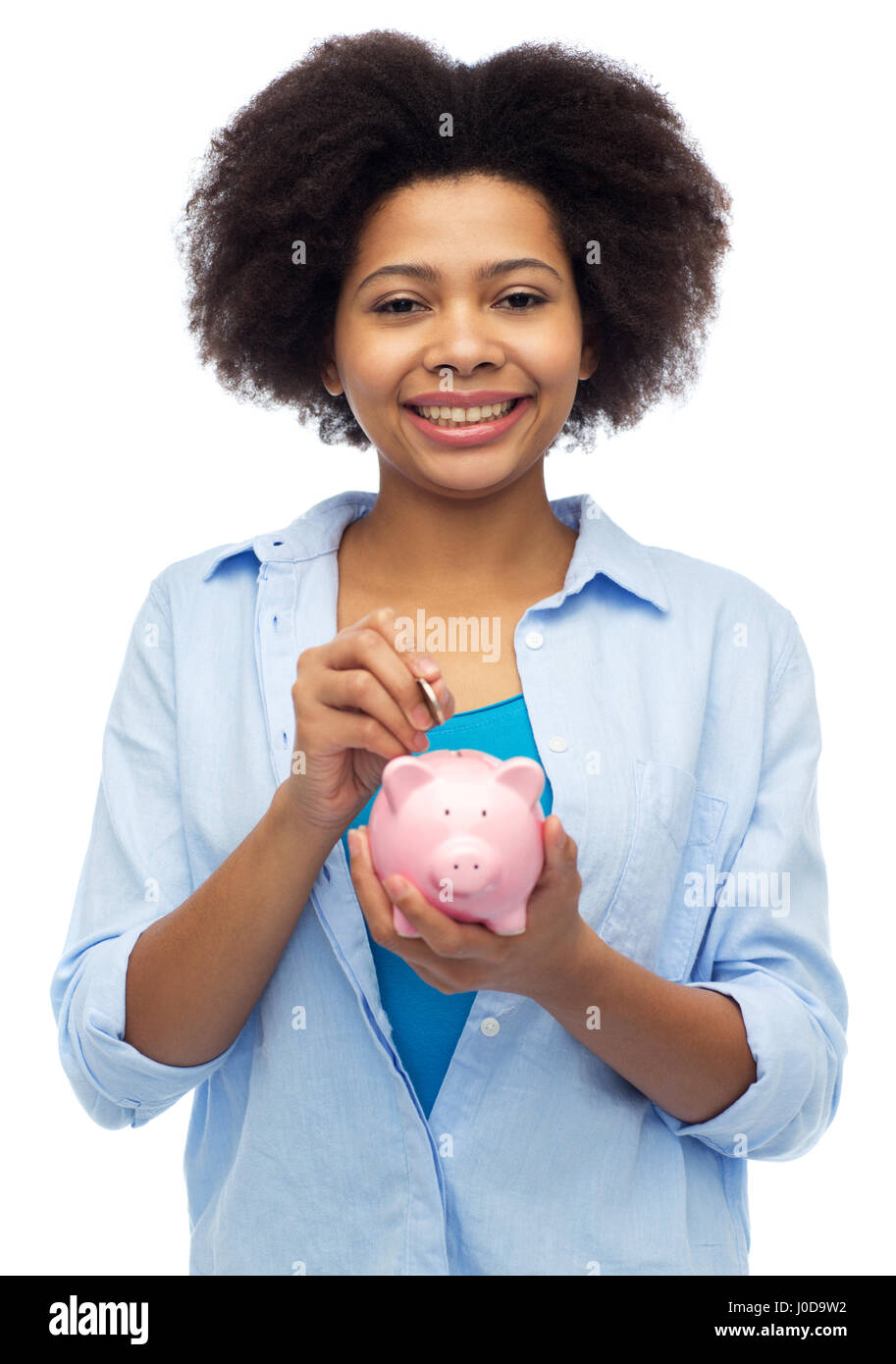 happy african woman putting coin into piggy bank Stock Photo - Alamy
