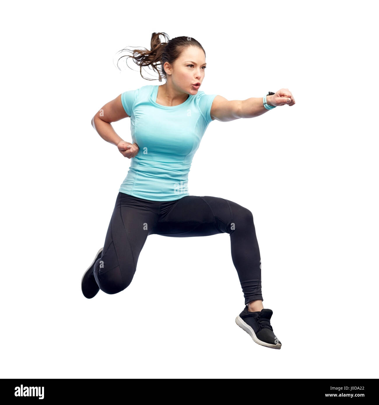 happy sporty young woman jumping in fighting pose Stock Photo - Alamy