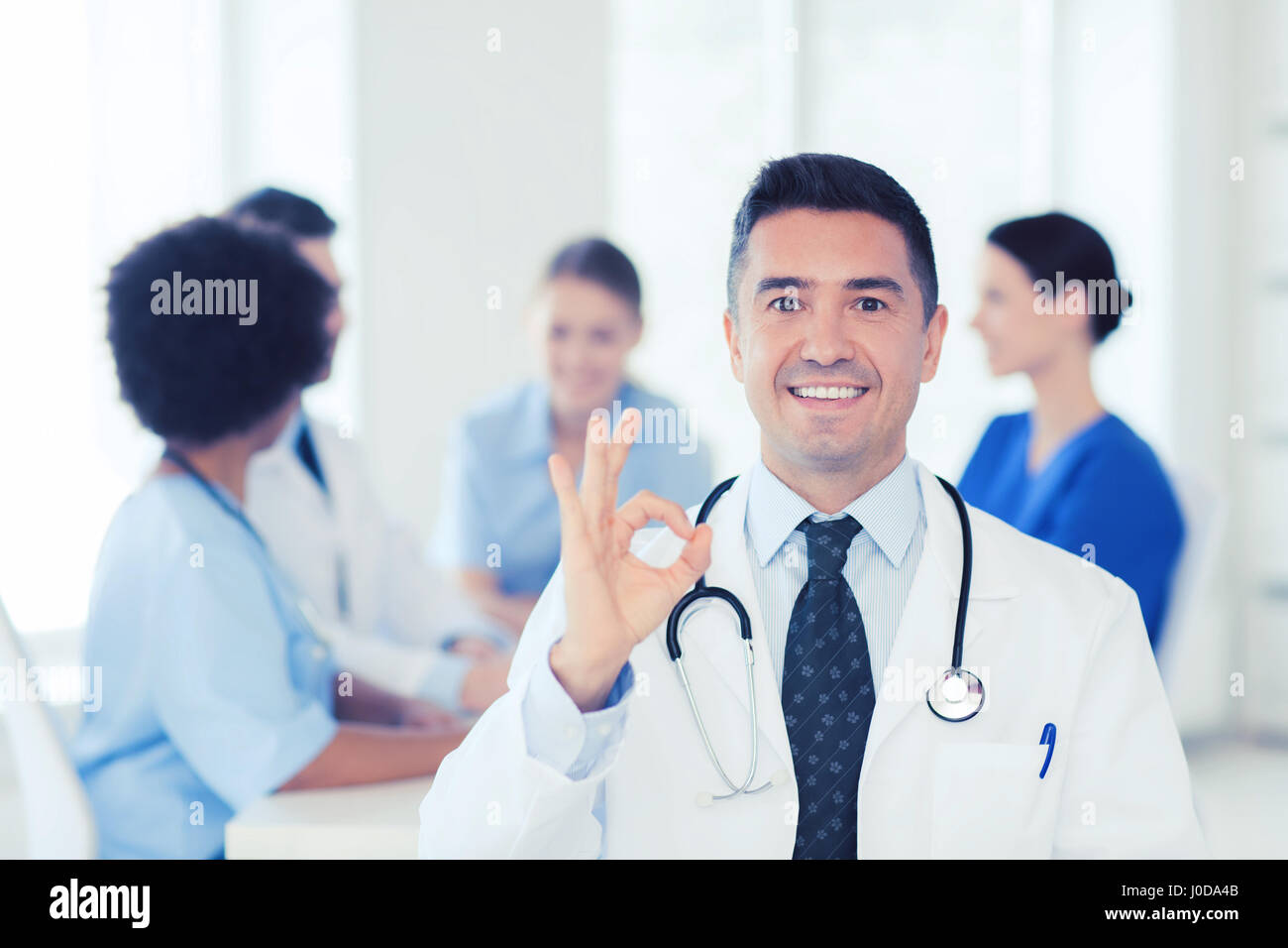 happy doctor over group of medics at hospital Stock Photo - Alamy