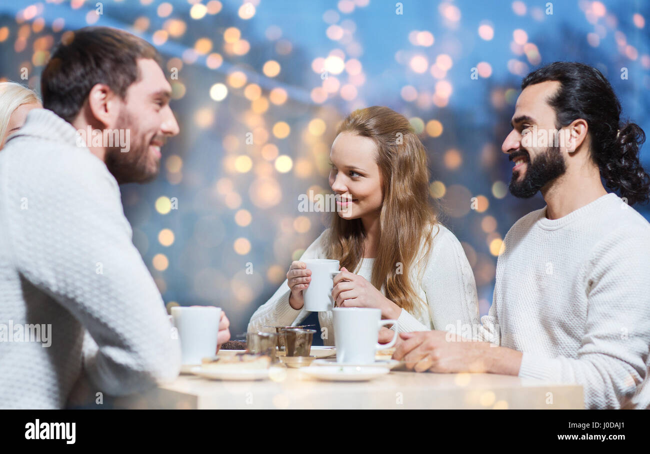 happy friends drinking tea at cafe Stock Photo - Alamy