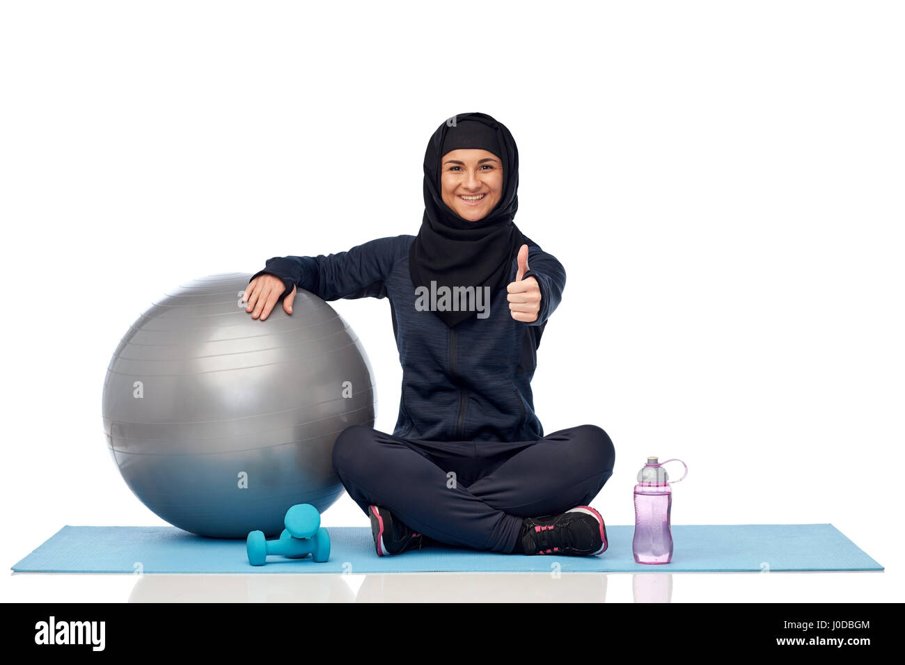 muslim woman in hijab with fitness ball and bottle Stock Photo - Alamy