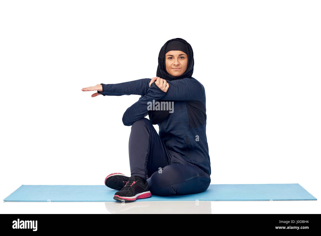 muslim woman doing sportand stretching on mat Stock Photo - Alamy