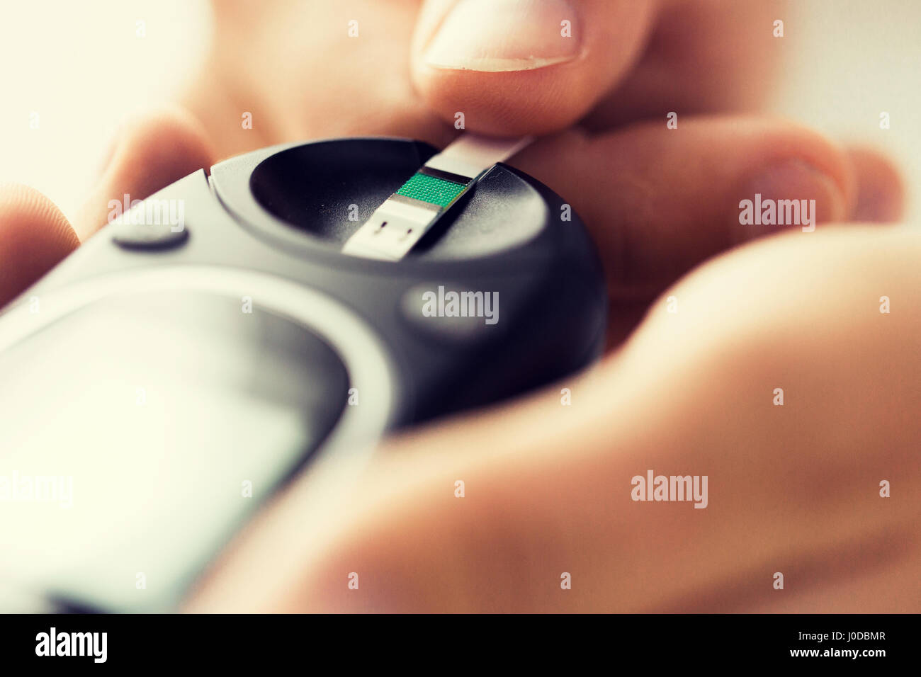 close up of man checking blood sugar by glucometer Stock Photo - Alamy