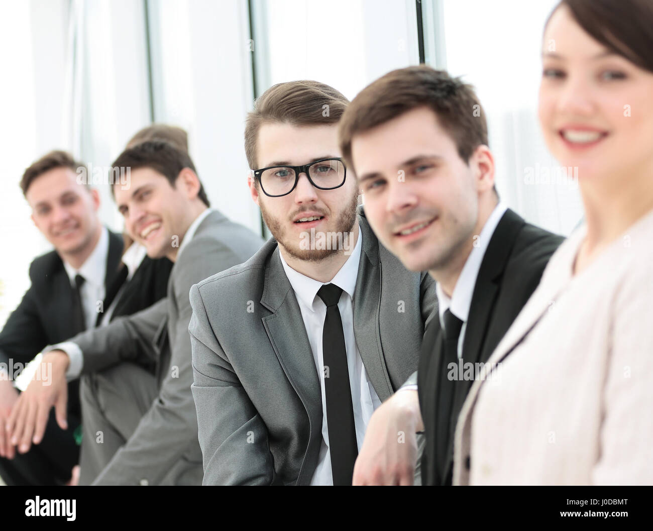 closeup of beautiful smiling woman administrator in a white suit and a ...