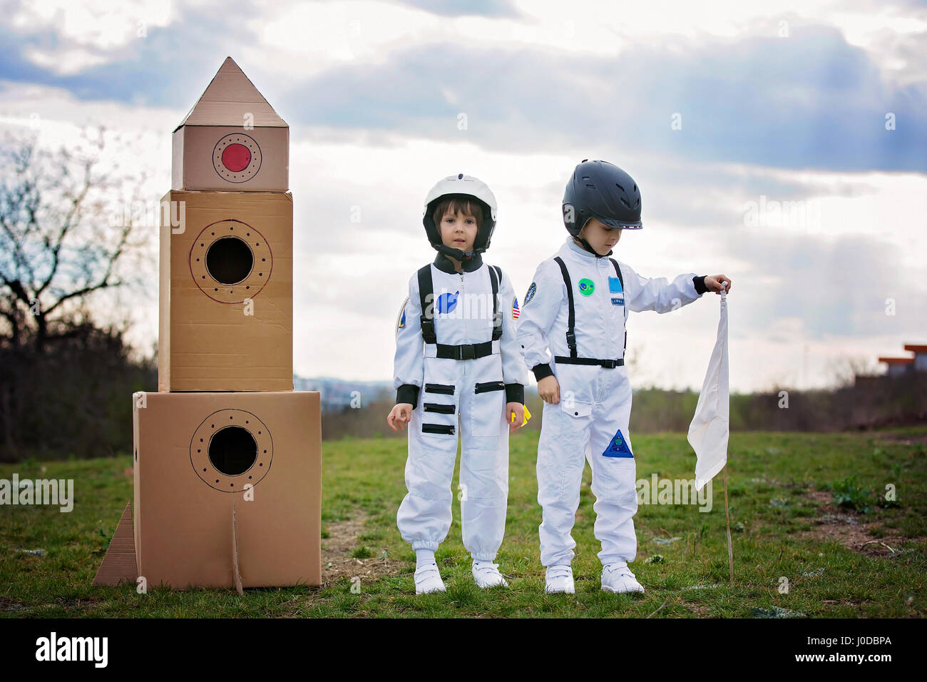Two adorable children, boy brothers, playing in park on sunset, dressed ...