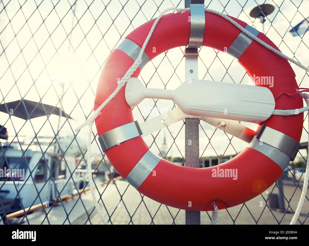 lifebuoy over moored boats on pier Stock Photo - Alamy