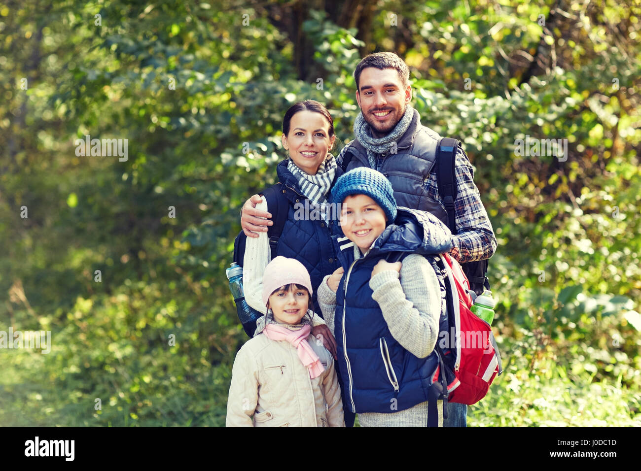 happy family with backpacks hiking Stock Photo - Alamy