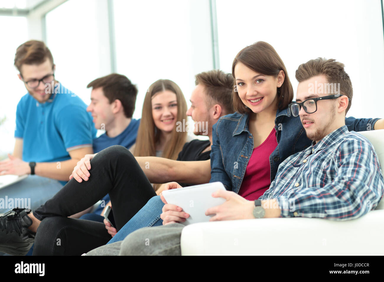closeup of a group of students resting after class in the foyer of the ...