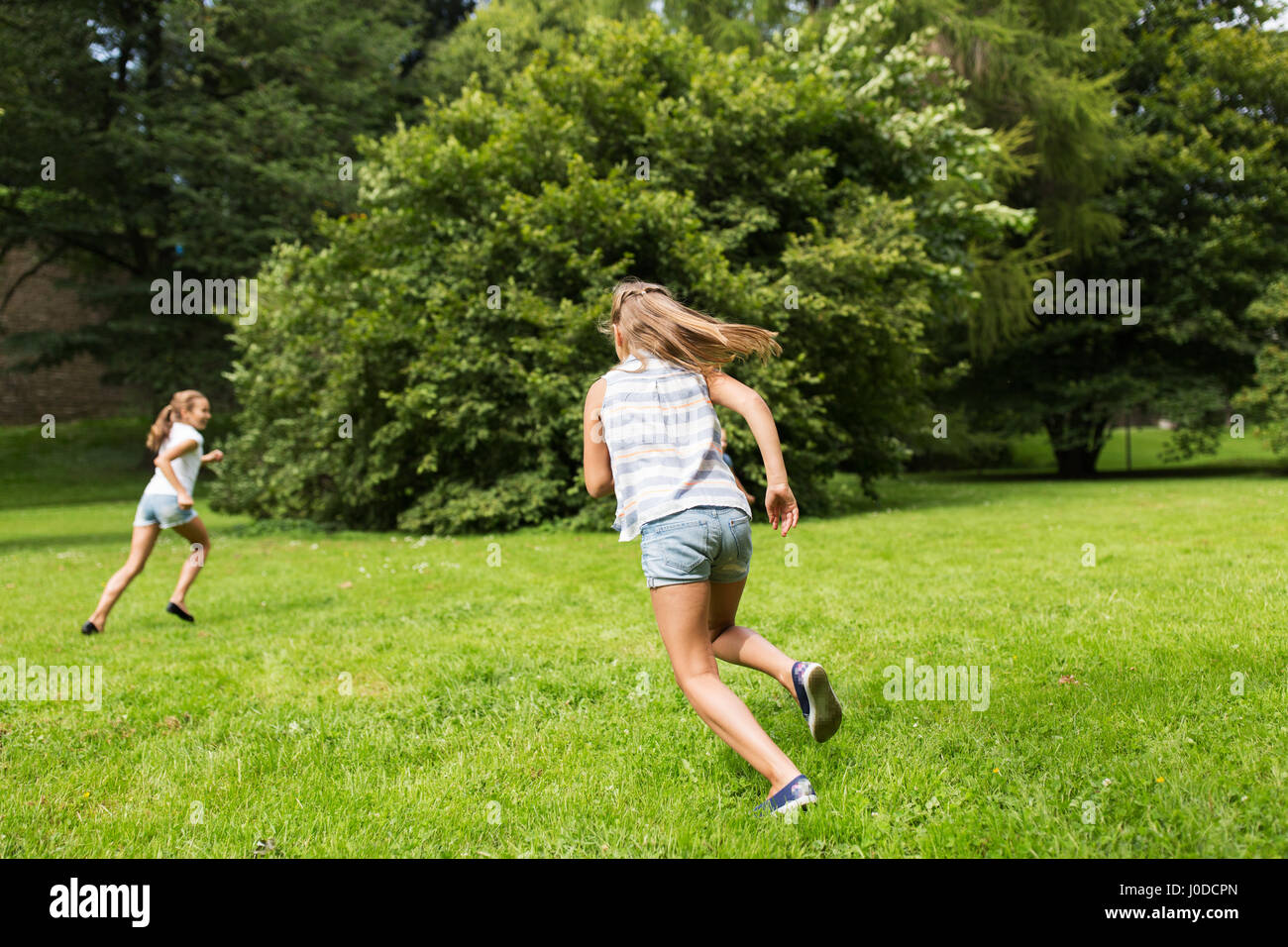 happy kids or friends playing outdoors Stock Photo - Alamy