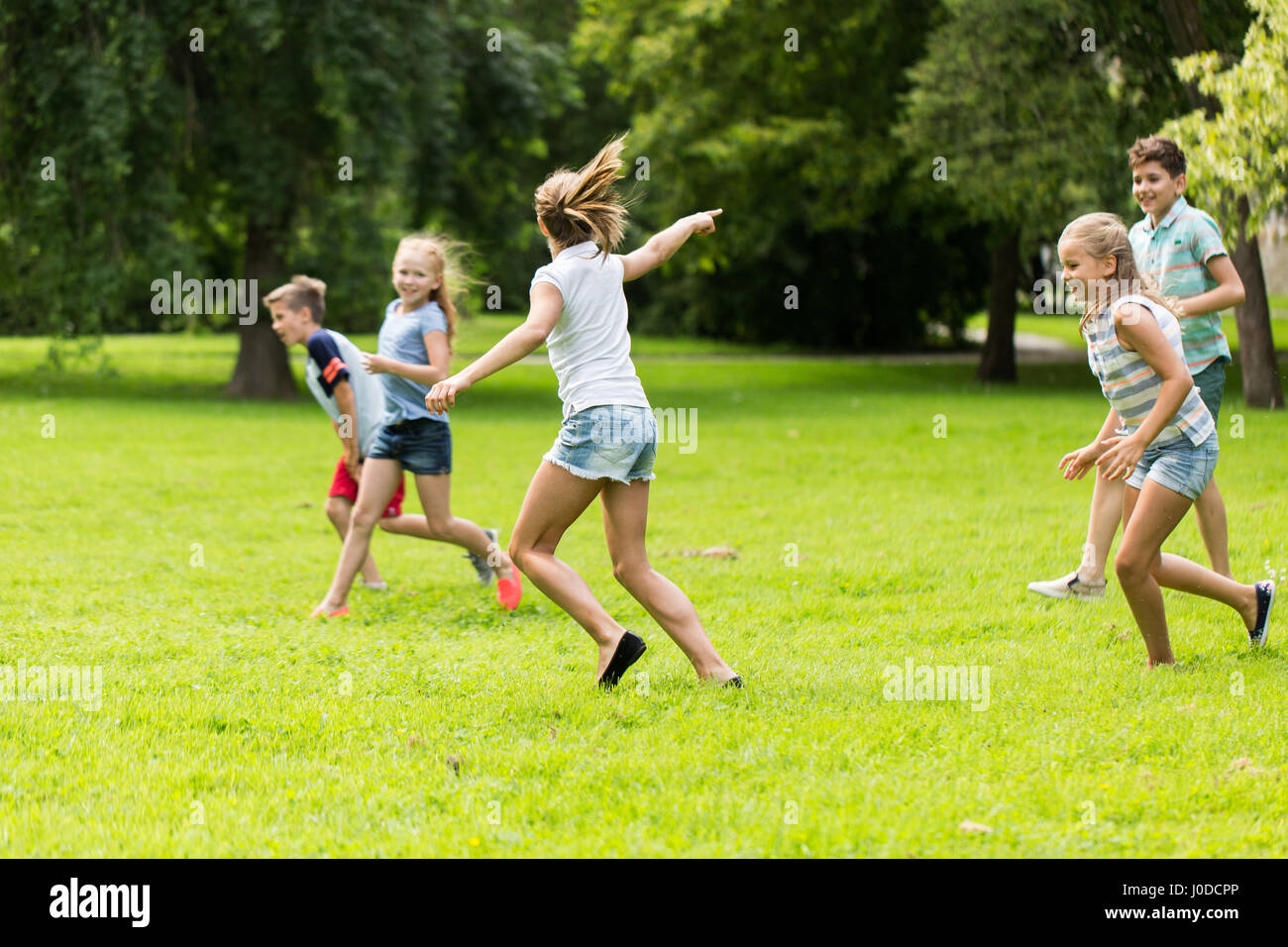 group of happy kids or friends playing outdoors Stock Photo - Alamy