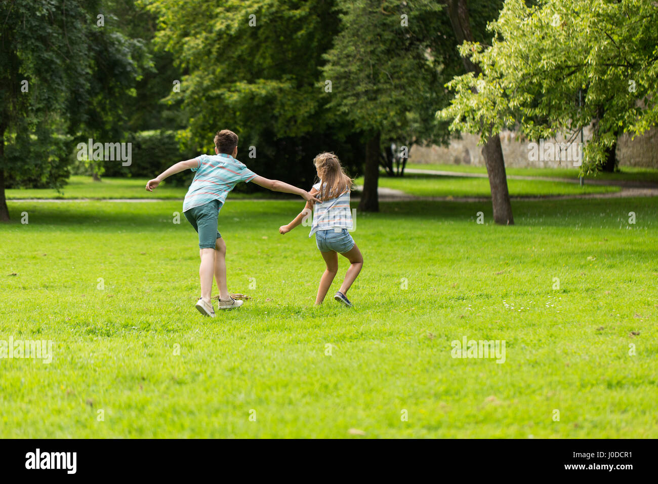 group of happy kids or friends playing outdoors Stock Photo - Alamy