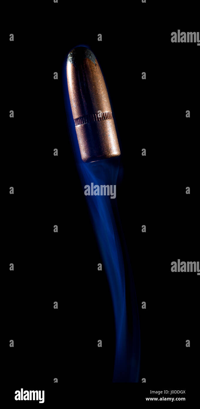 Blue smoke trailing a bullet as it goes skyward on black Stock Photo ...