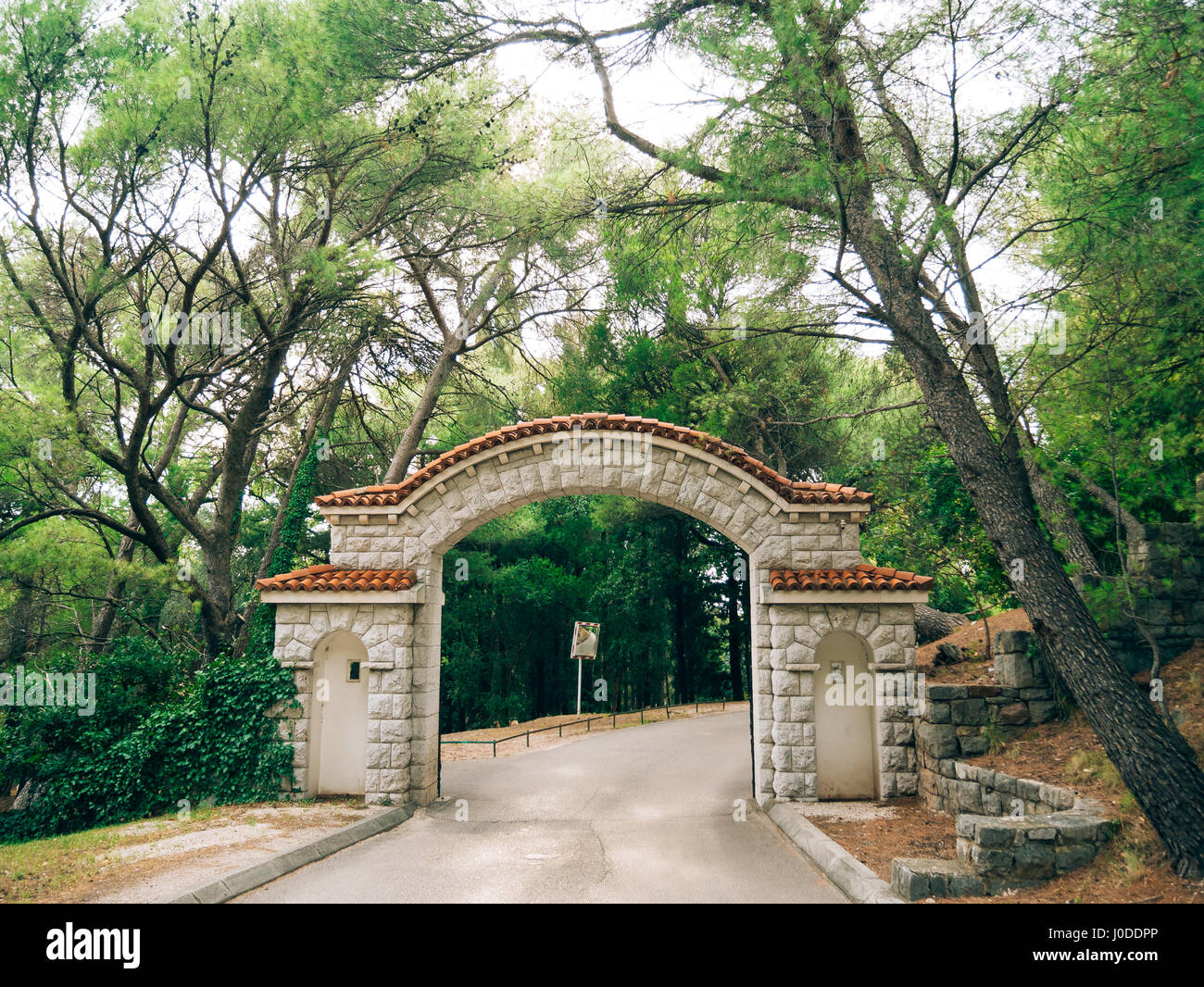 Stone Gate with a tiled roof in the forest. Handmade. Exterior d Stock ...