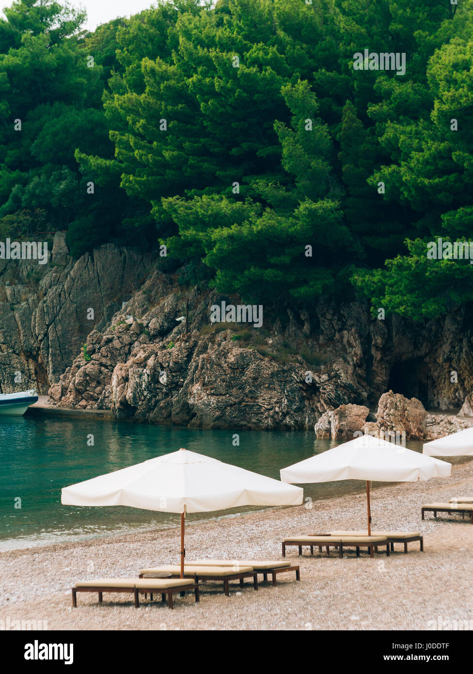 Sun beds and umbrellas on the beach. Montenegrin beaches of the Stock ...