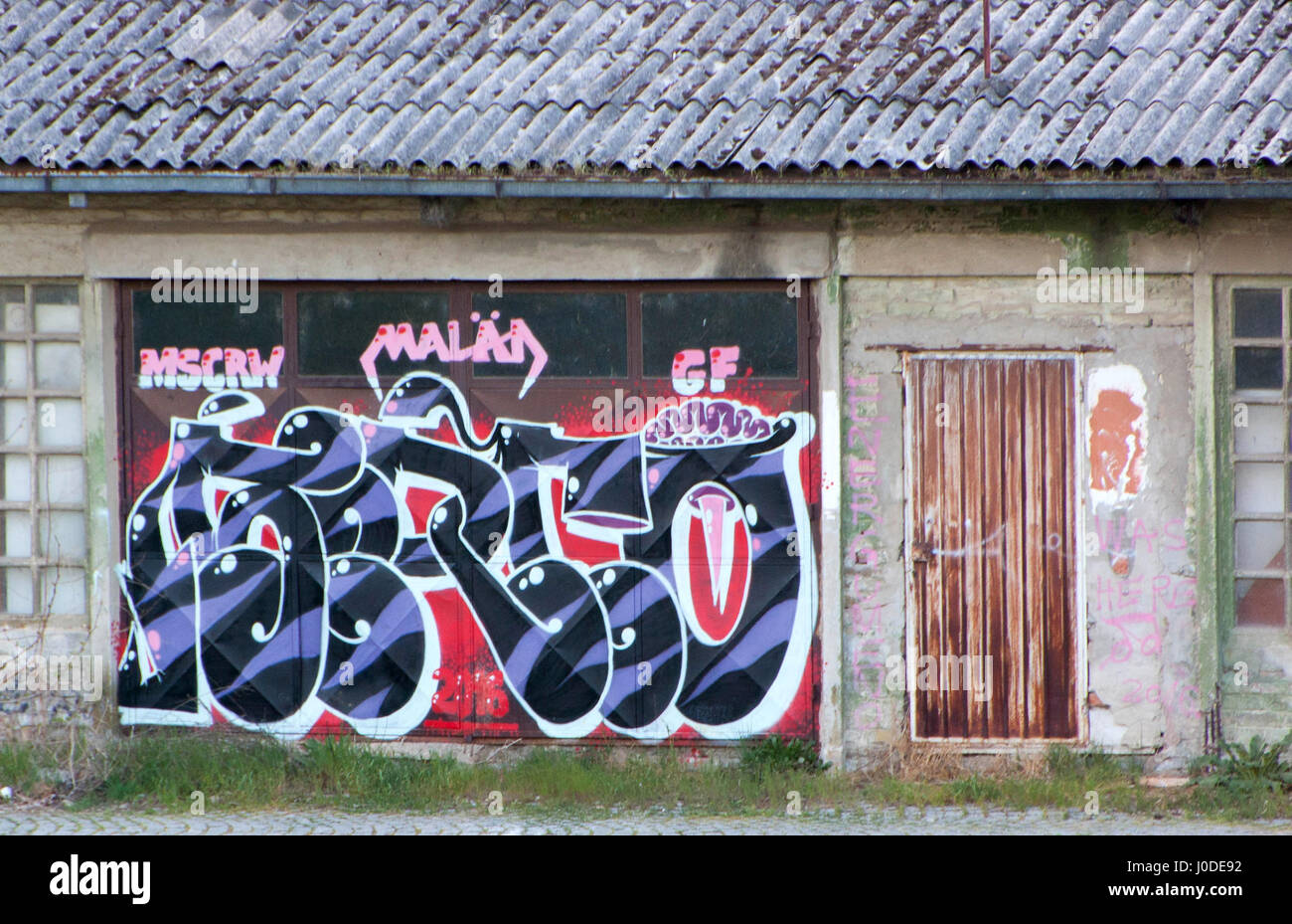 Wall of abandoned building, painted with graffiti Stock Photo - Alamy