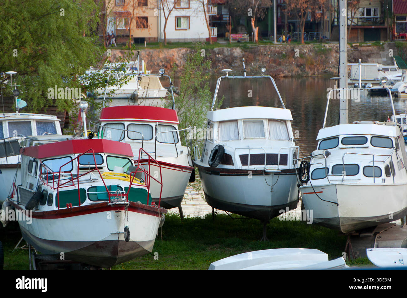 Boats and floating houses in the harbor. House was built on a steel ...