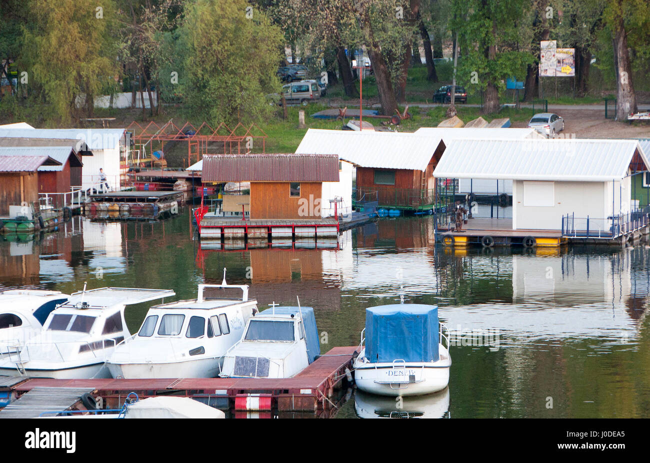 Boats and floating houses in the harbor. House was built on a steel ...