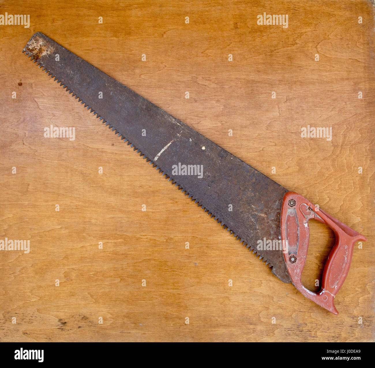 old rusty saw on the wooden background Stock Photo - Alamy