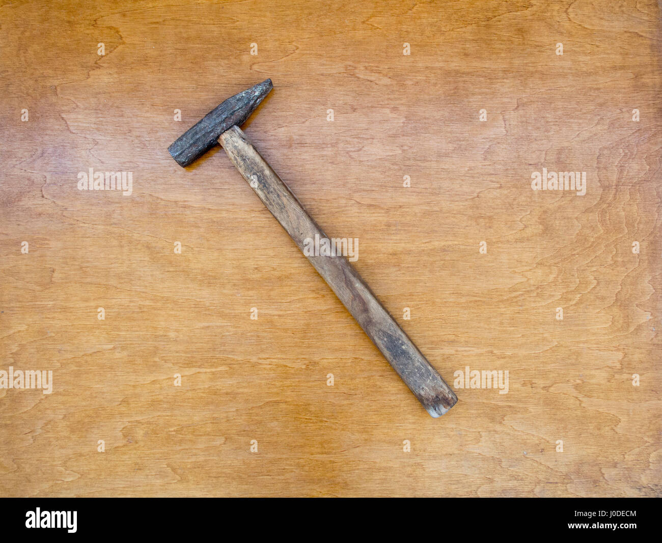 Old rusty hammer on wooden background Stock Photo - Alamy
