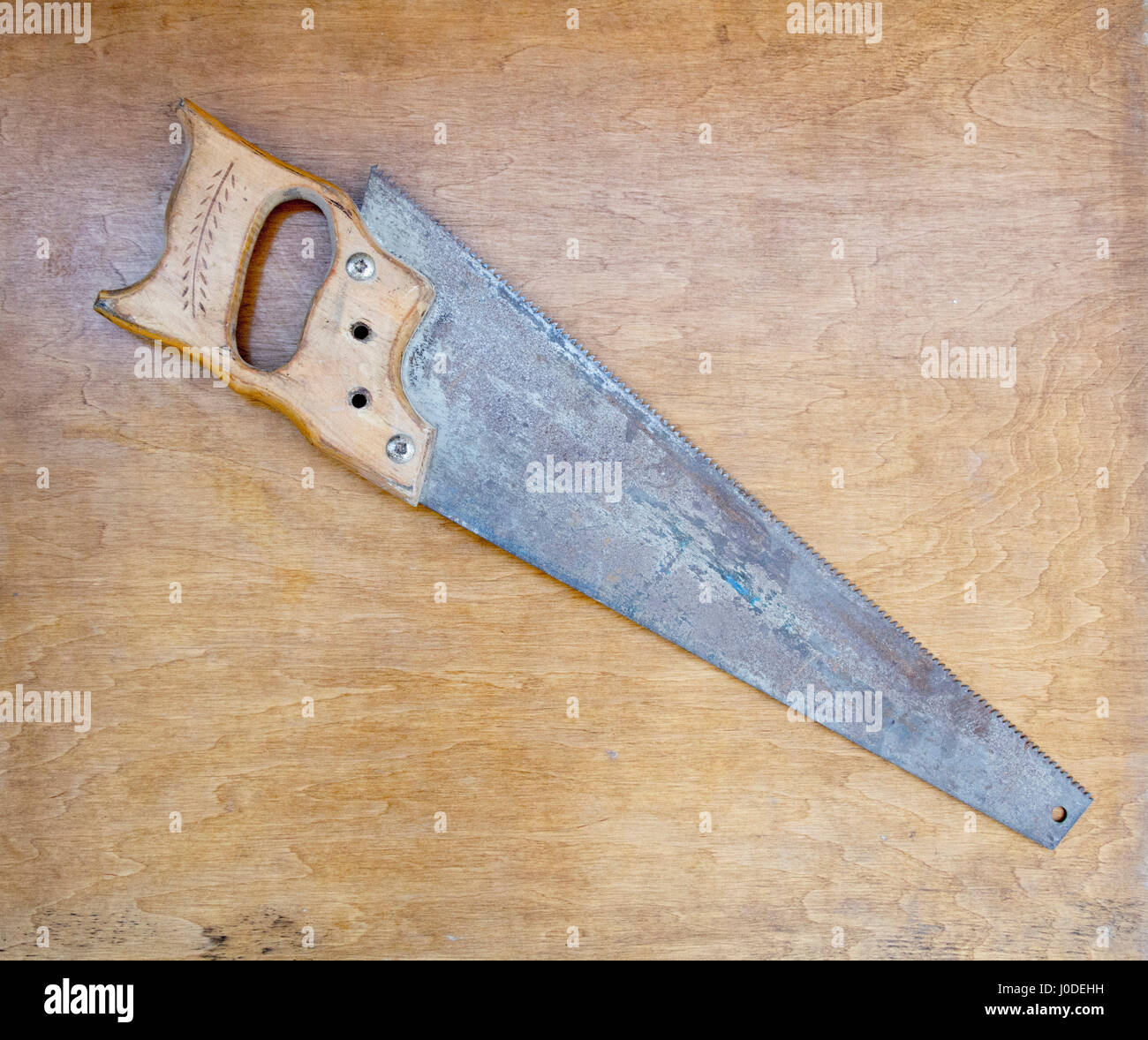 Rusty crosscut hand saw handsaw tool on wooden background Stock Photo ...
