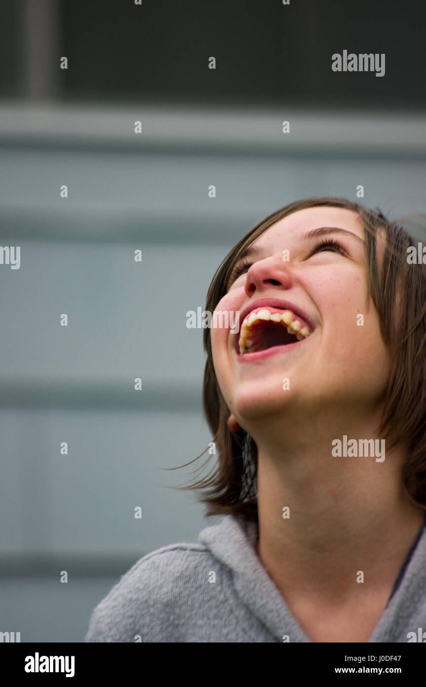 Young girl looking up with big smile on face Stock Photo - Alamy