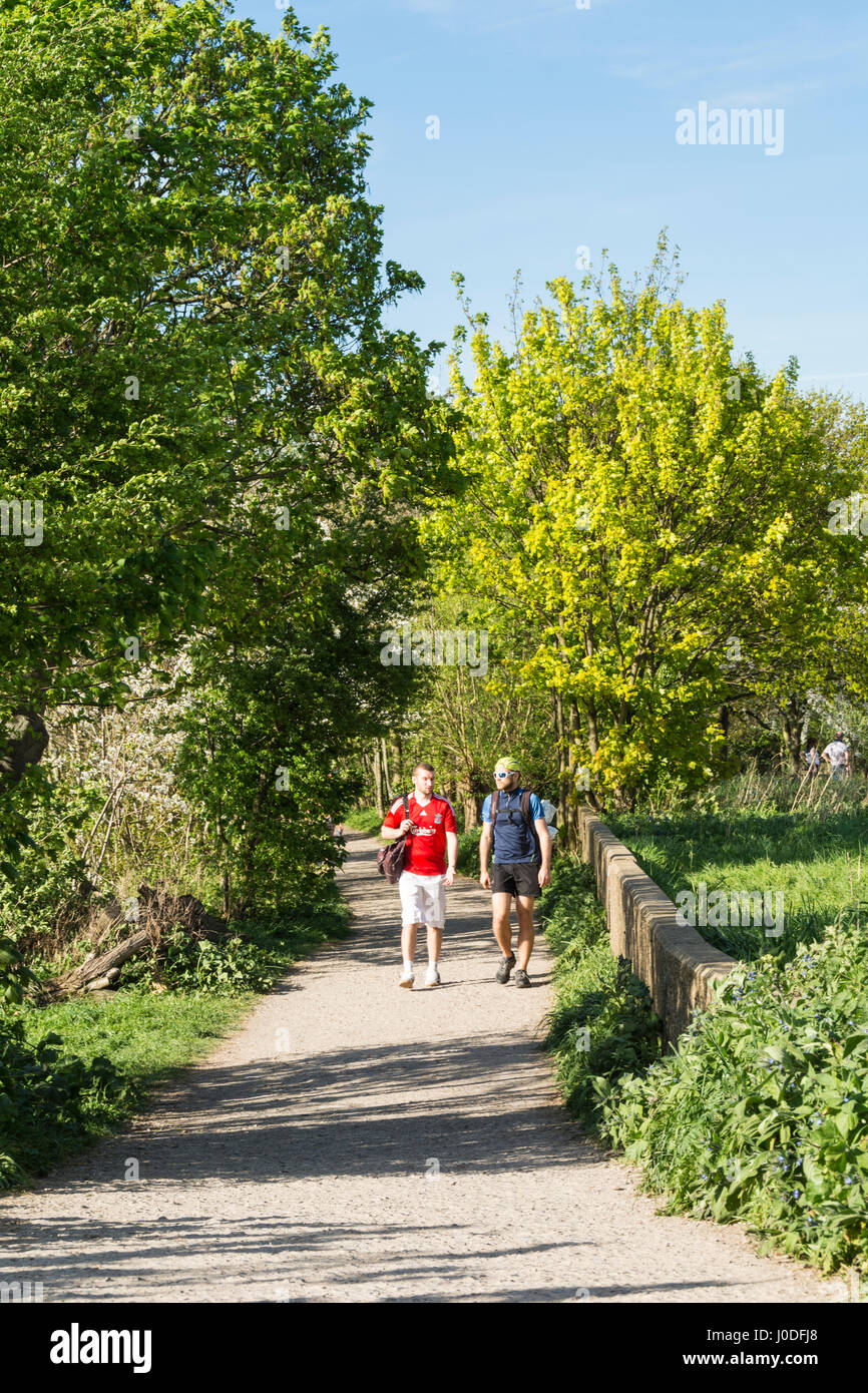 Two men walking along the towpath beside the River Thames in southwest ...