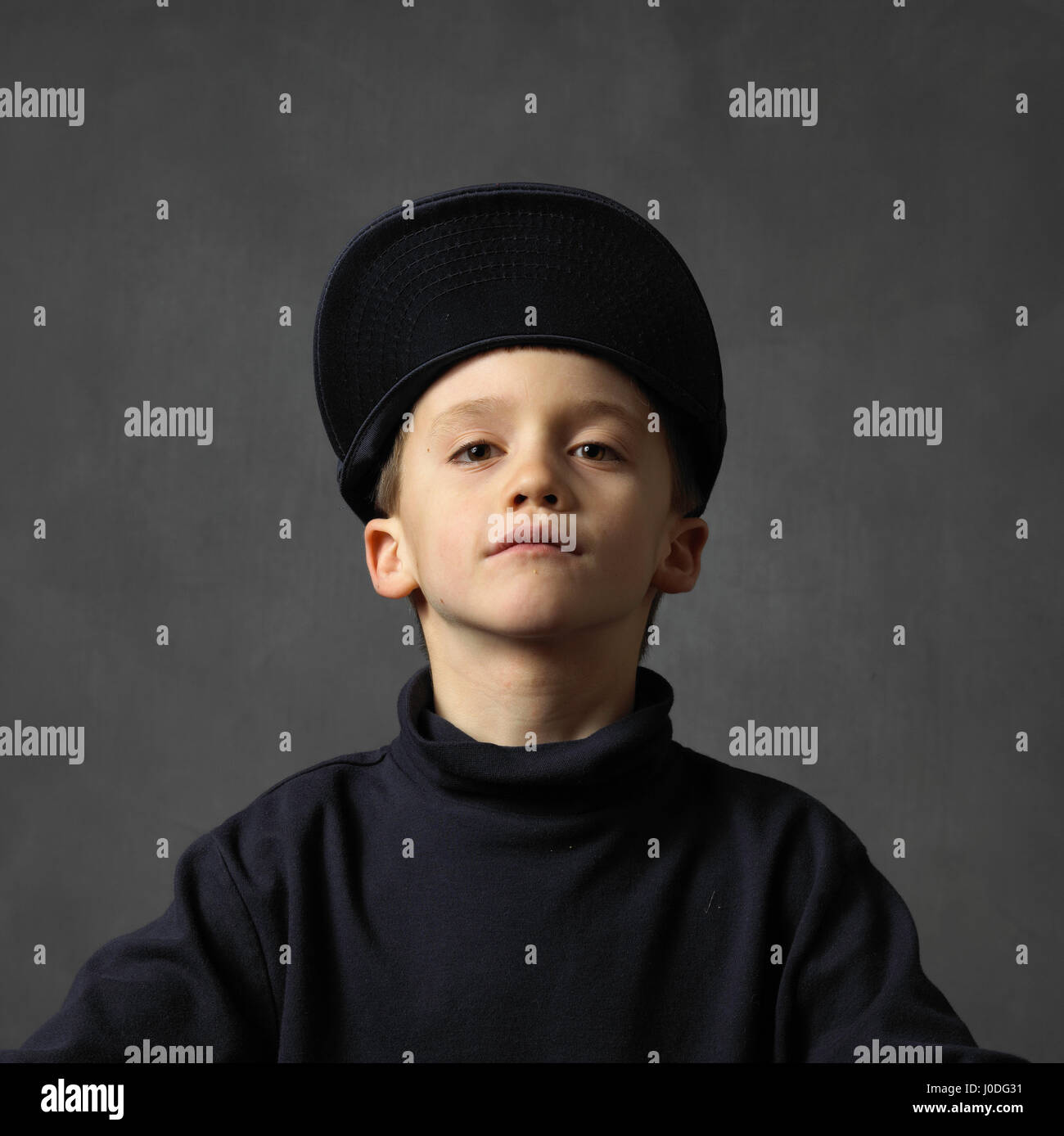 Young boy poses with assorted hats, straw, construction, hard, top ...