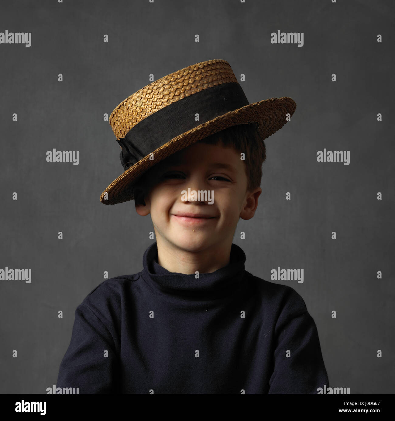 Young boy poses with assorted hats, straw, construction, hard, top ...
